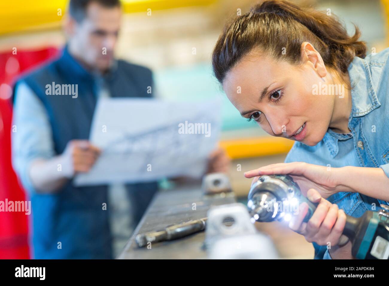 beautiful female at work using a drilling machine Stock Photo - Alamy
