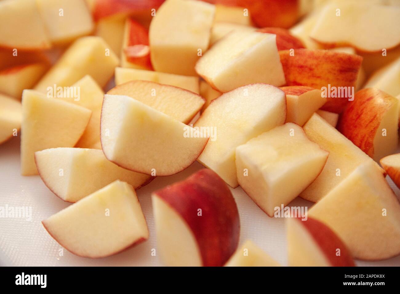 white fresh juicy insides of diced up apples ready for baking Stock ...