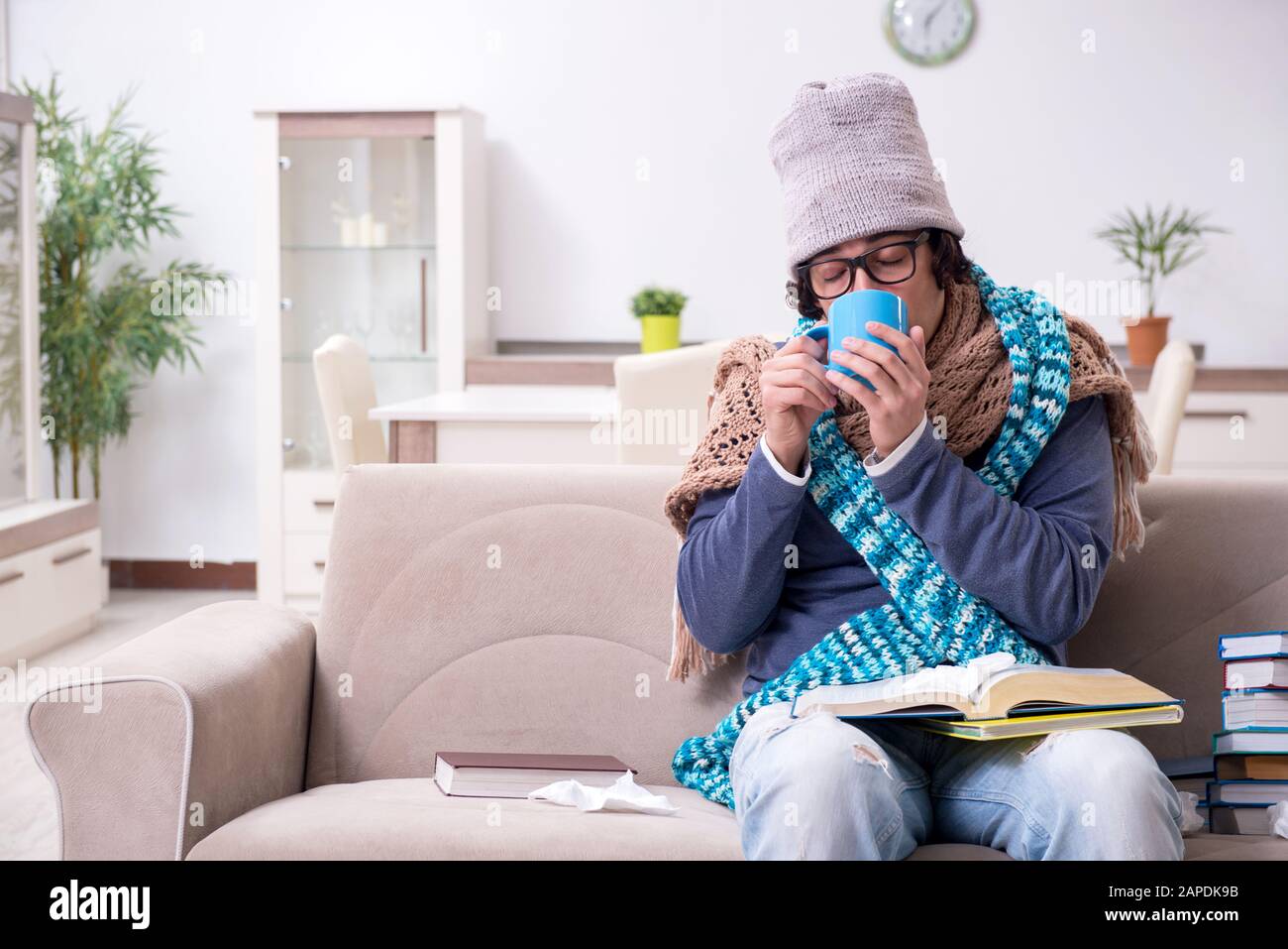 The sick male student suffering at home Stock Photo - Alamy