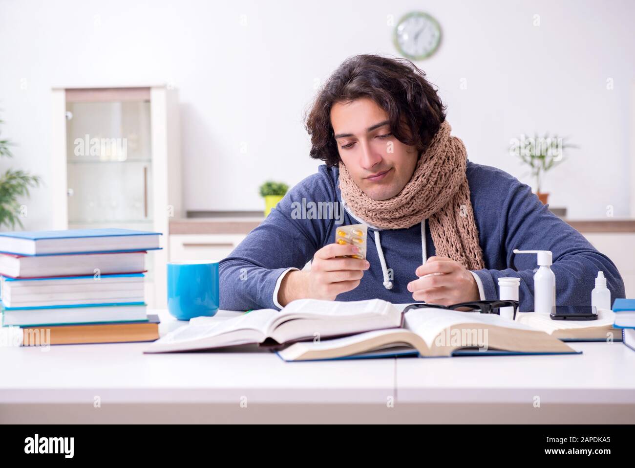 The sick male student suffering at home Stock Photo - Alamy