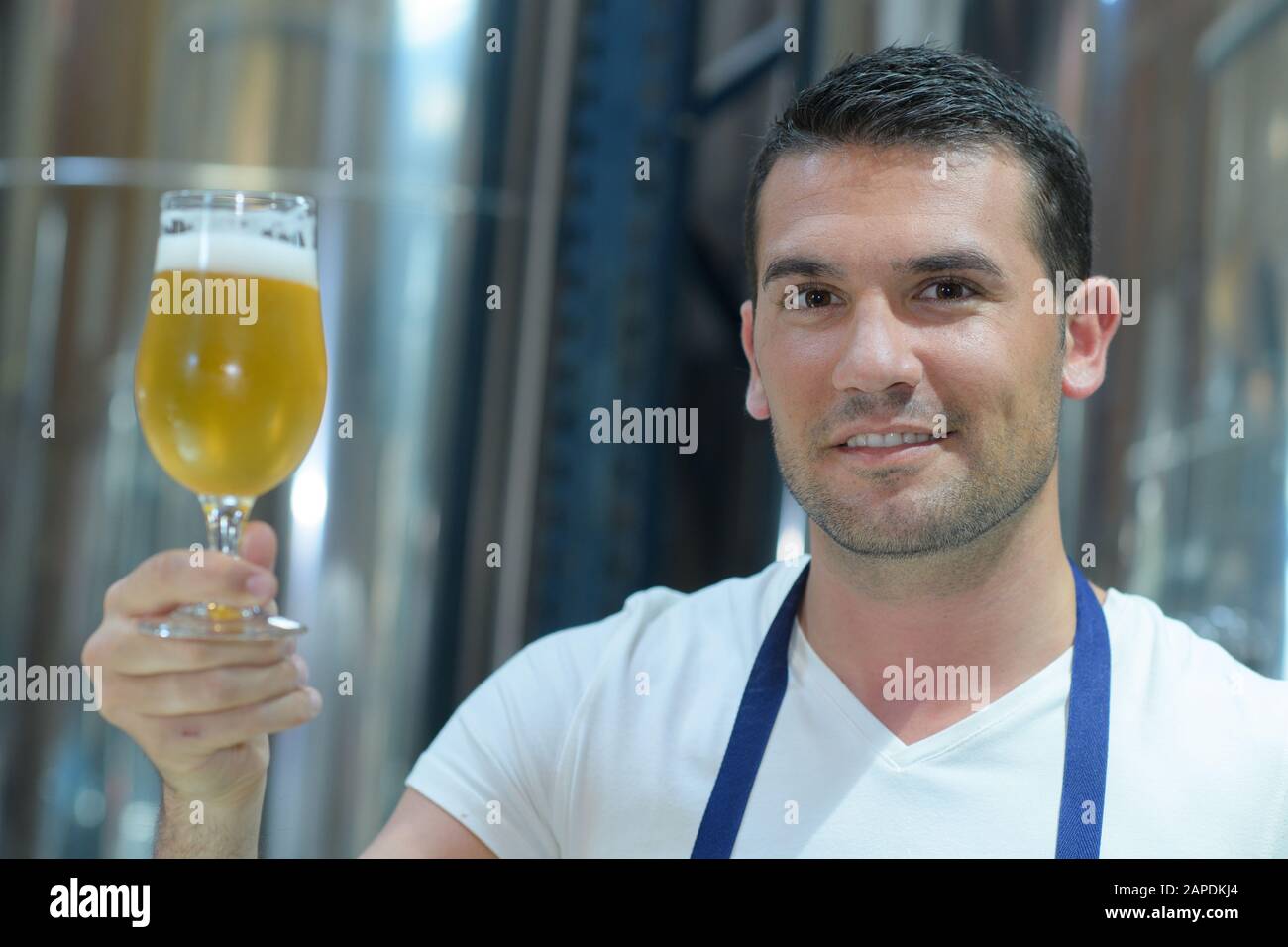 handsome brewer in uniform checking quality of the beer Stock Photo - Alamy
