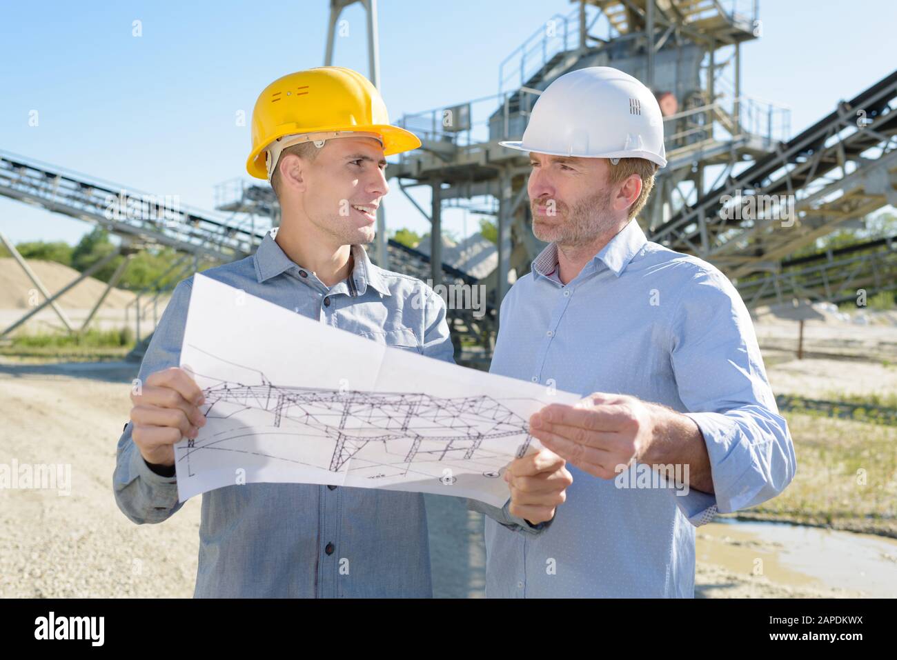 young engineer holding blueprint of structure frame Stock Photo - Alamy