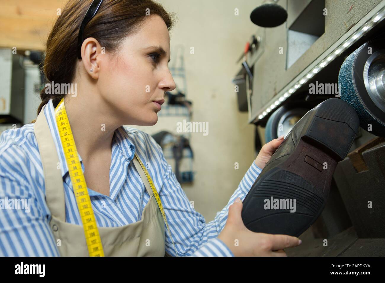 a shoemaker repairs a shoe Stock Photo - Alamy