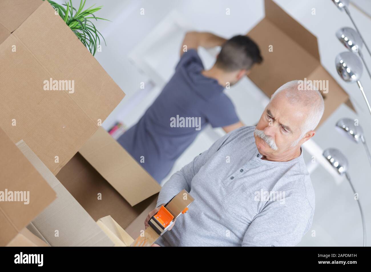 portrait of men packing their boxes Stock Photo - Alamy
