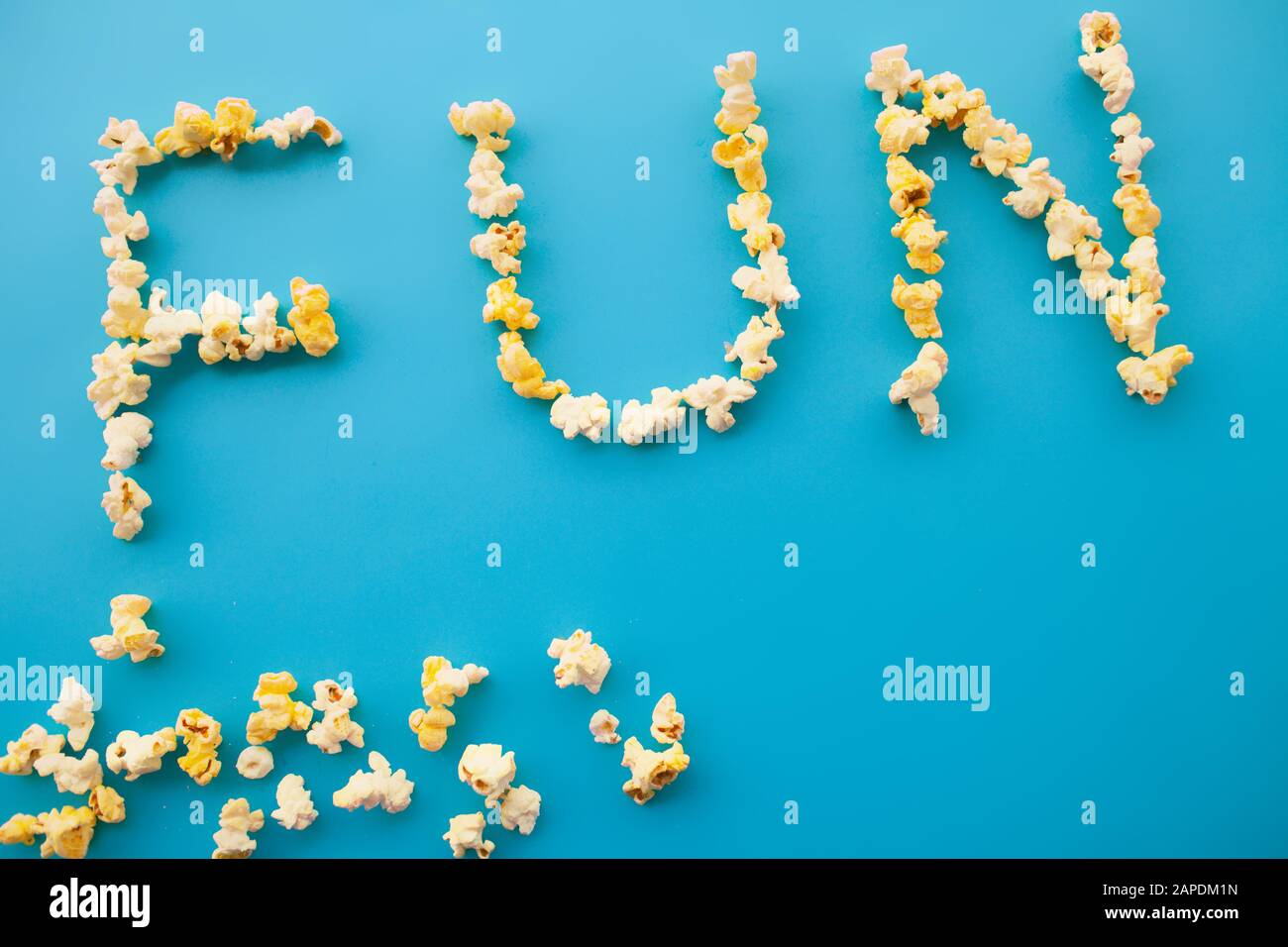 Food. Word of Fun. Popcorn bucket. Delicious Popcorn on Blue Background ...
