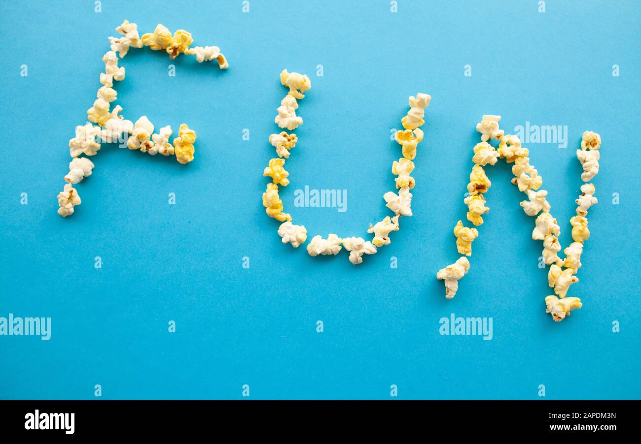 Food. Word of Fun. Popcorn bucket. Delicious Popcorn on Blue Background ...