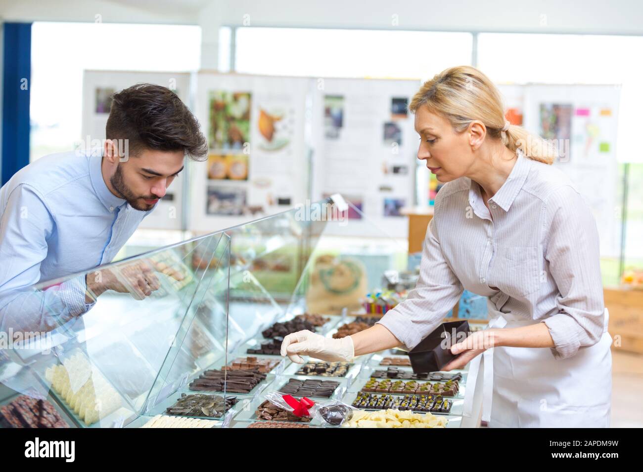 Adult woman selling chocolates hi-res stock photography and images - Alamy