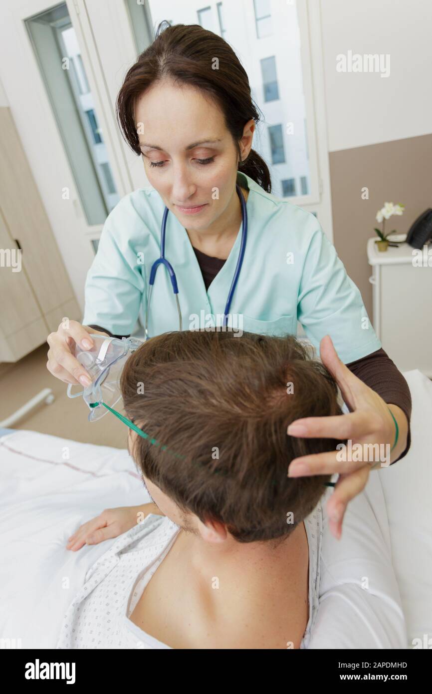 nurse practicing how to provide oxygen administration to a patient ...