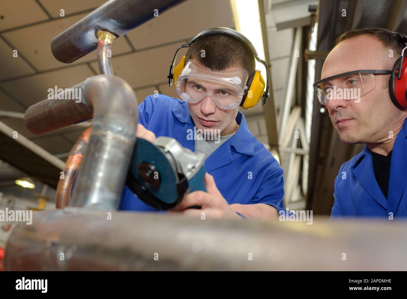 apprentice using a grinding machine Stock Photo - Alamy