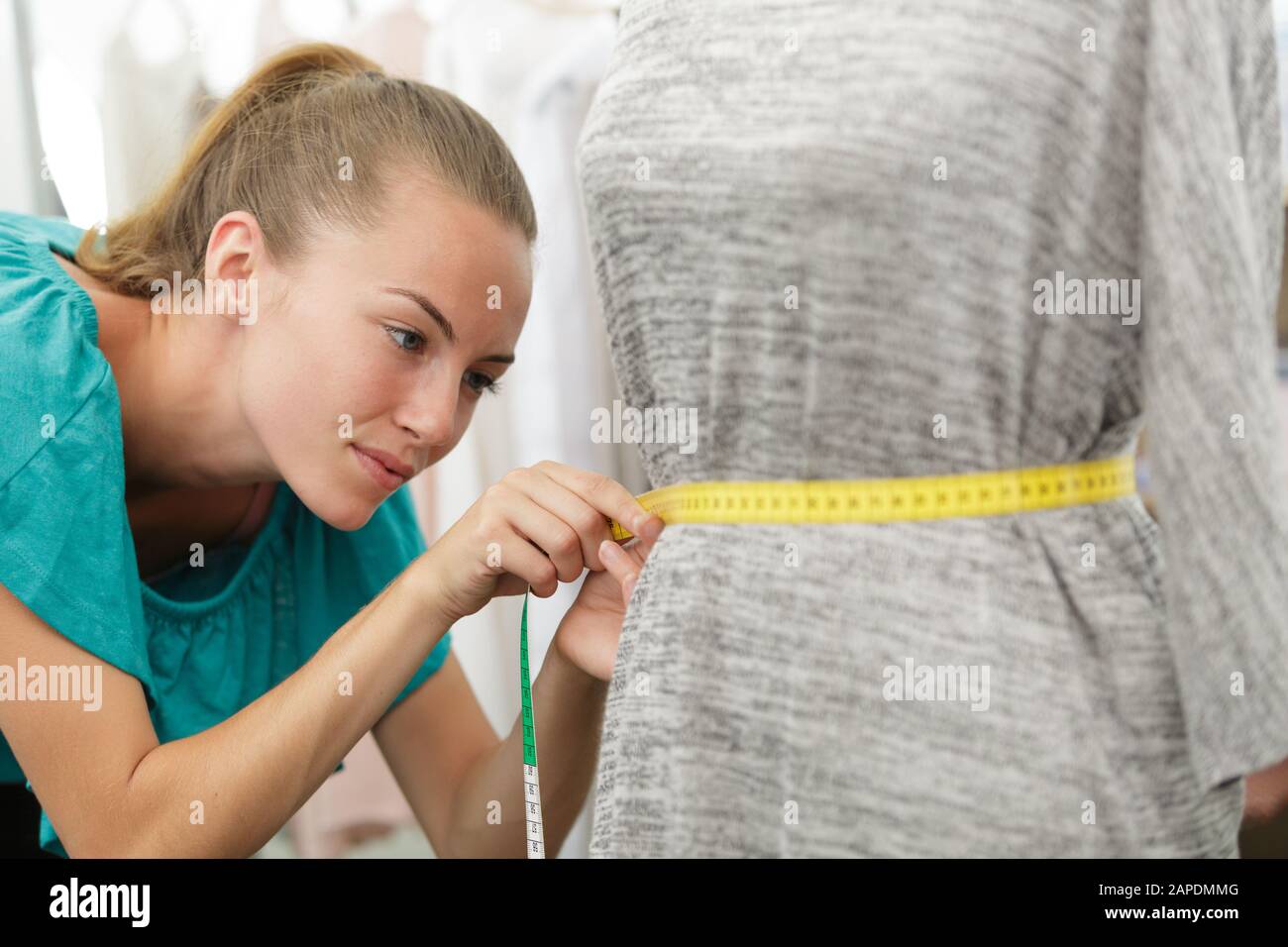 a tailor measuring a dummy Stock Photo - Alamy