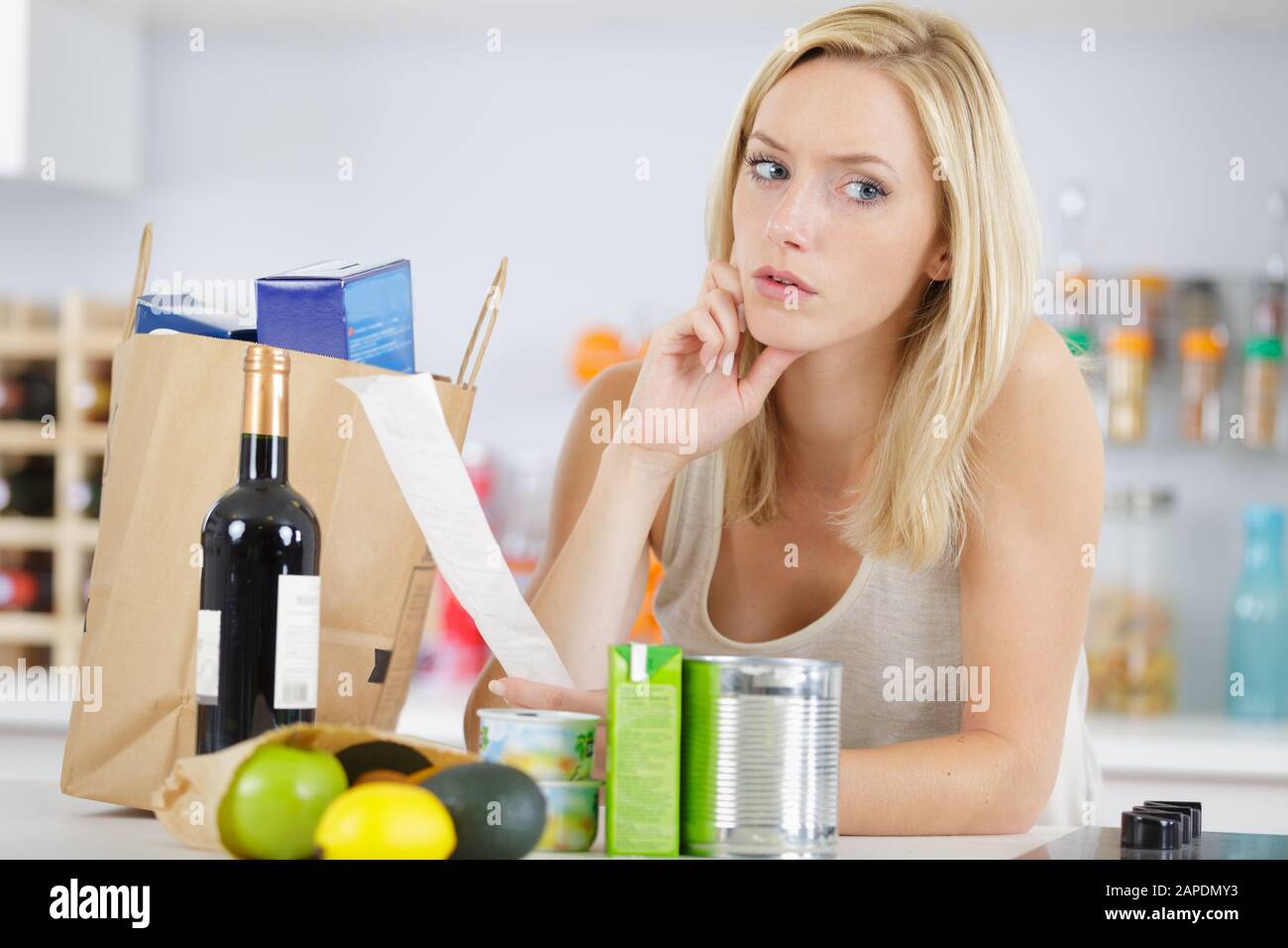 worried woman holding a bill receipt Stock Photo - Alamy