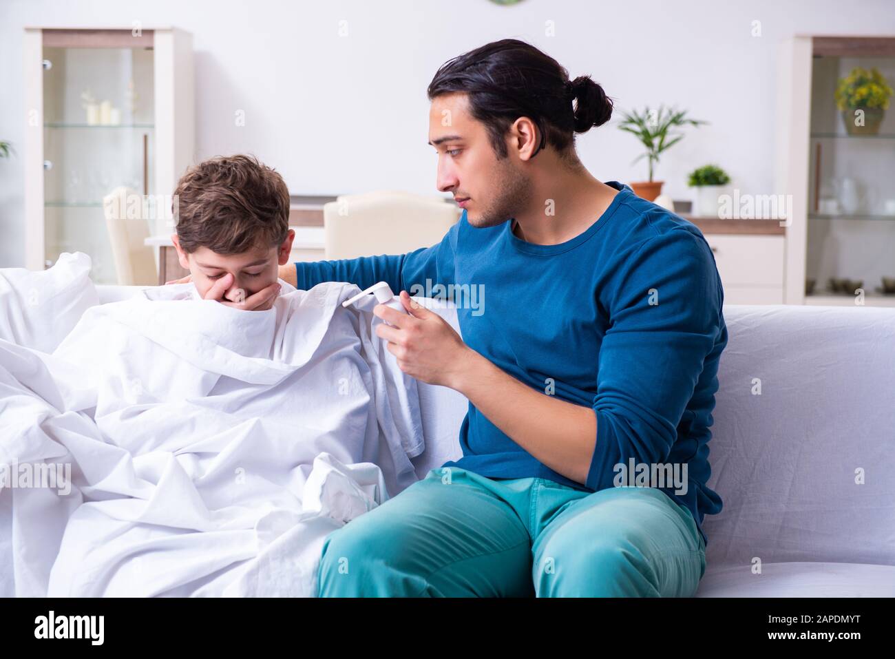 The young father caring for sick son Stock Photo - Alamy