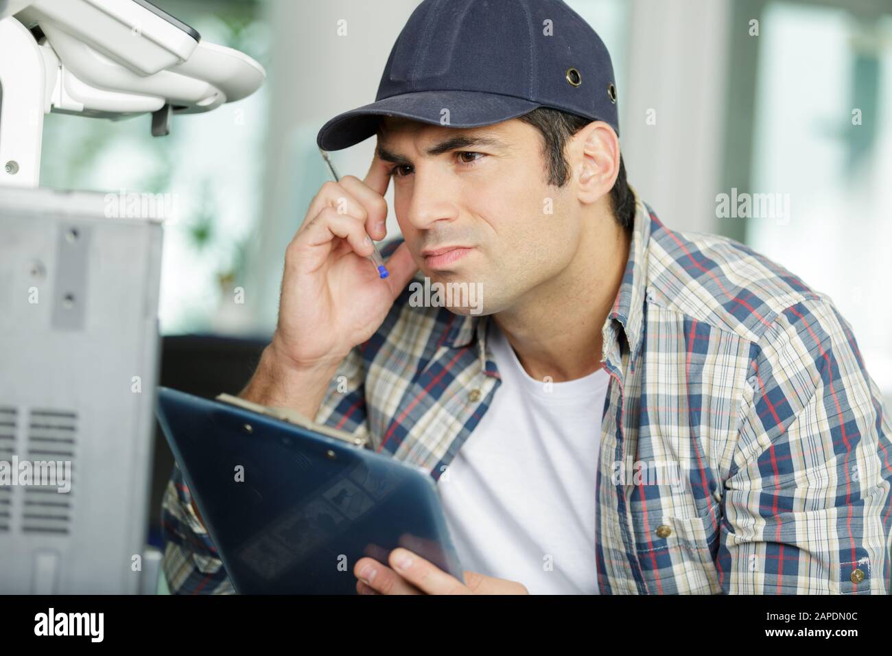 technician thinking about work assignments Stock Photo - Alamy