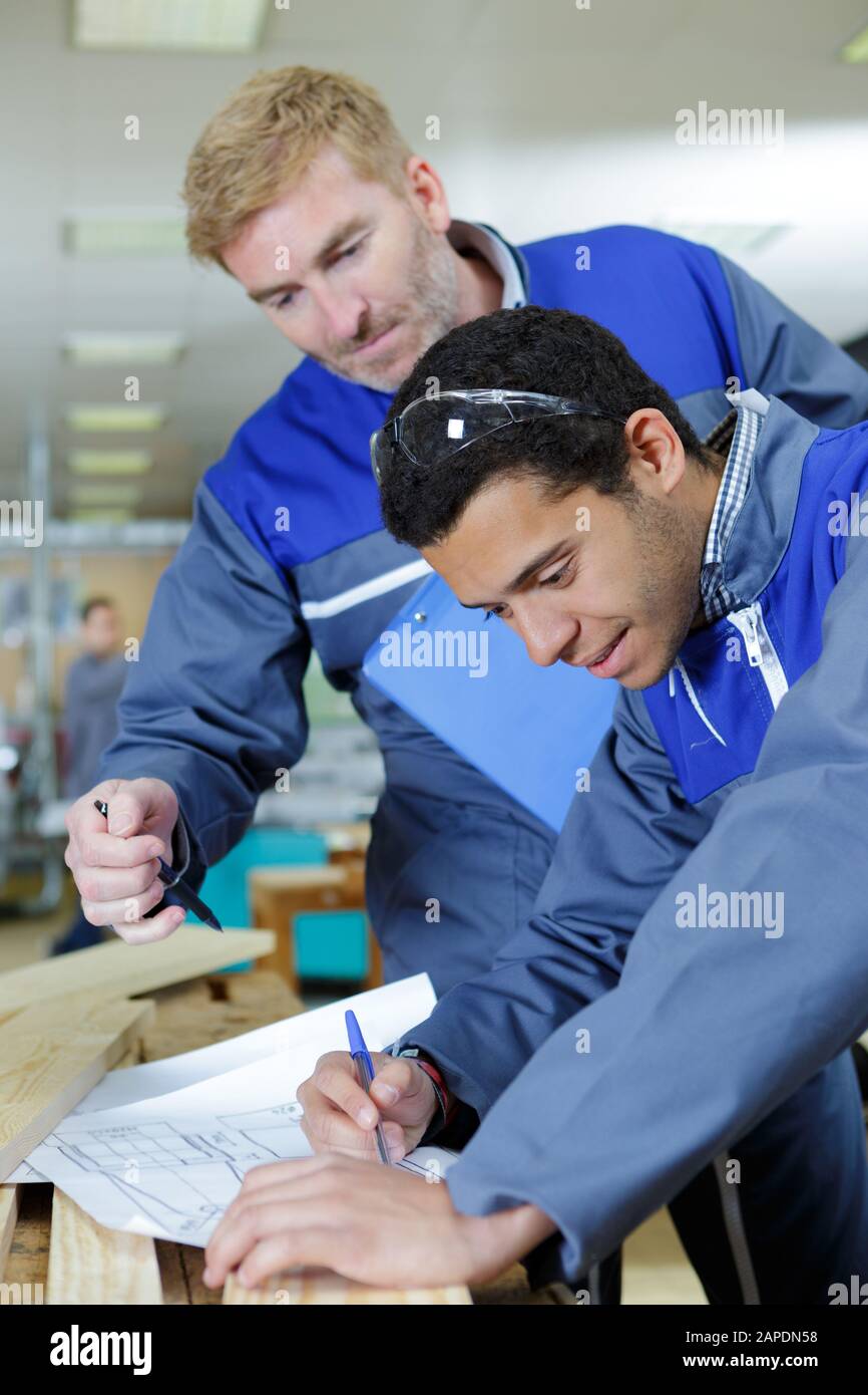 production man workers writing on clipboard Stock Photo - Alamy