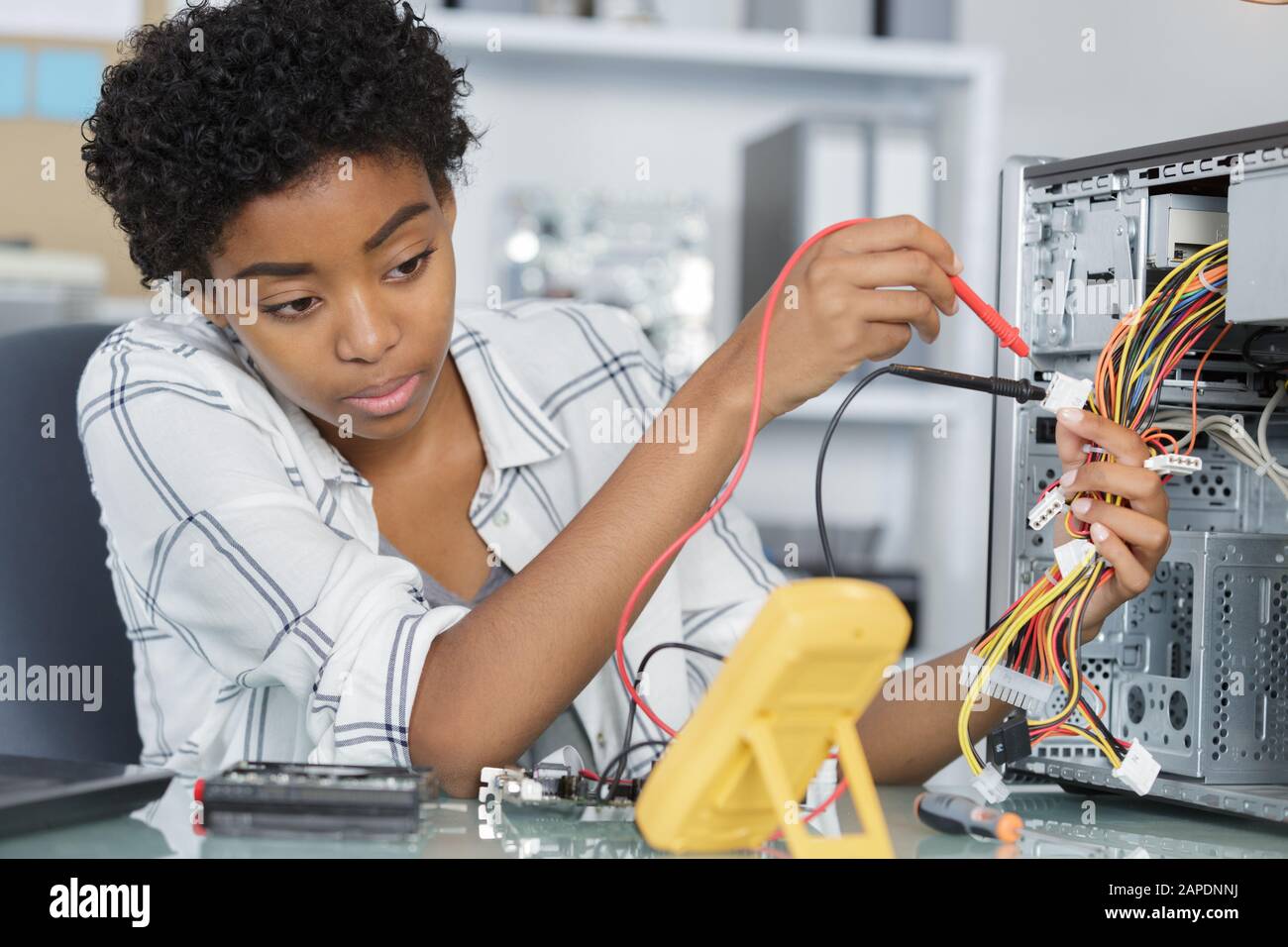 female technician during voltage measurement in computer cables Stock ...