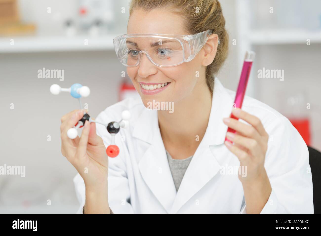 happy scientist holding samples with positive testing solution Stock ...