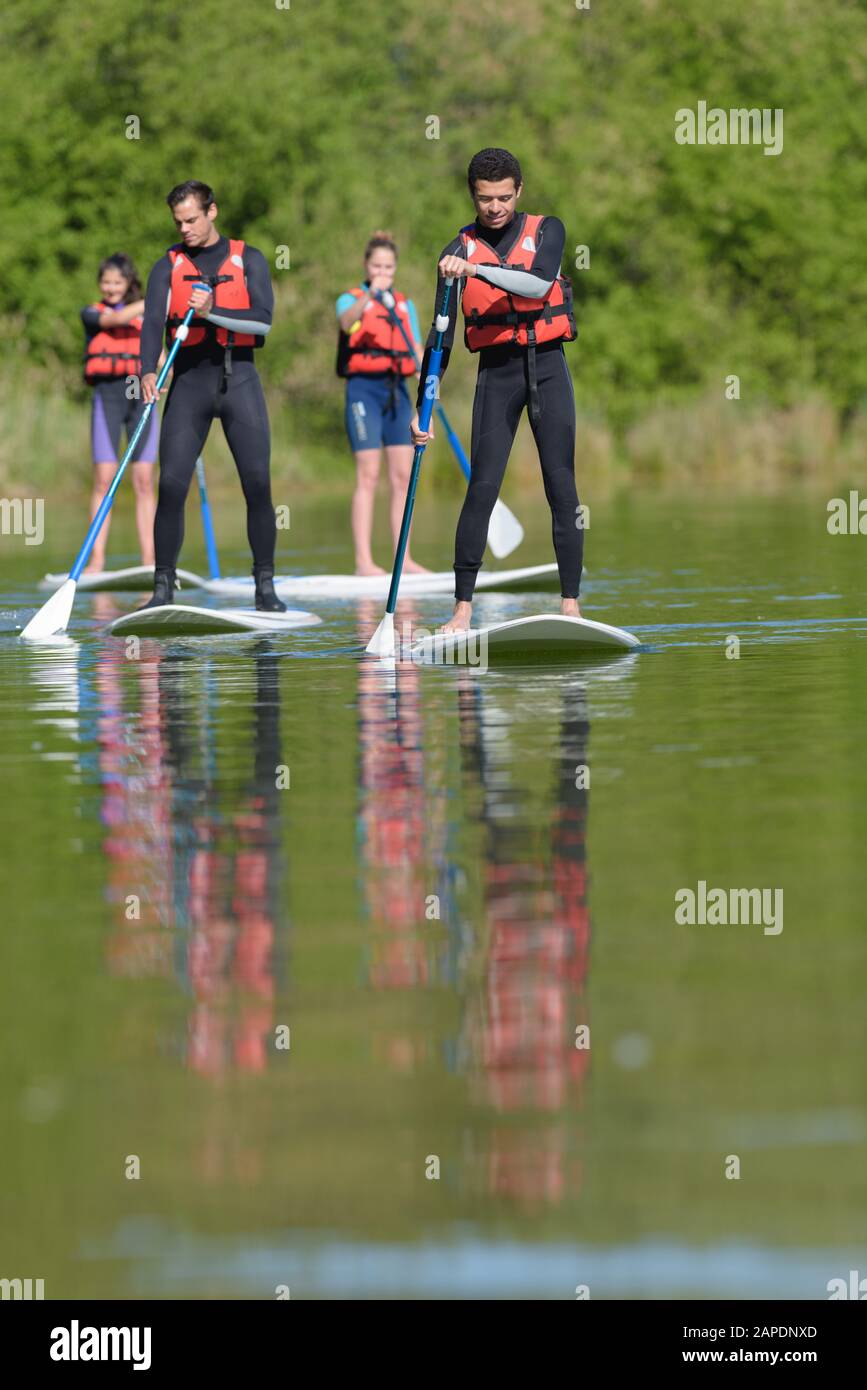 people on a stand up paddle board paddeling Stock Photo - Alamy