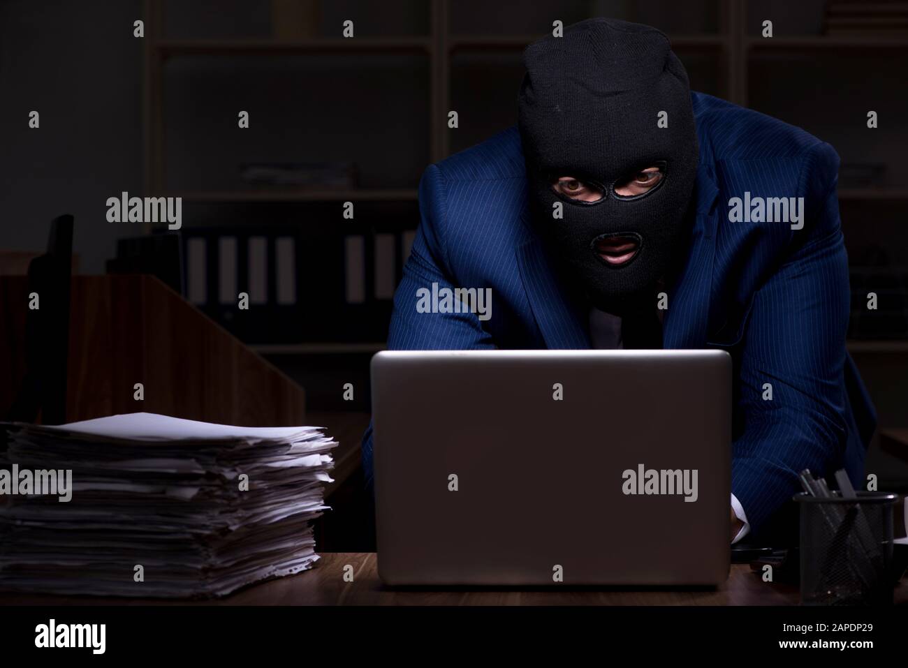 The male employee stealing information in the office night time Stock ...