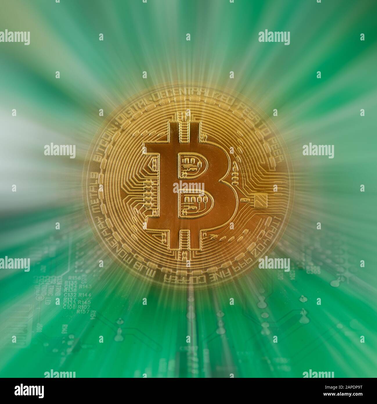 Zooming in on a gold color physical bitcoin crypto currency with green ...
