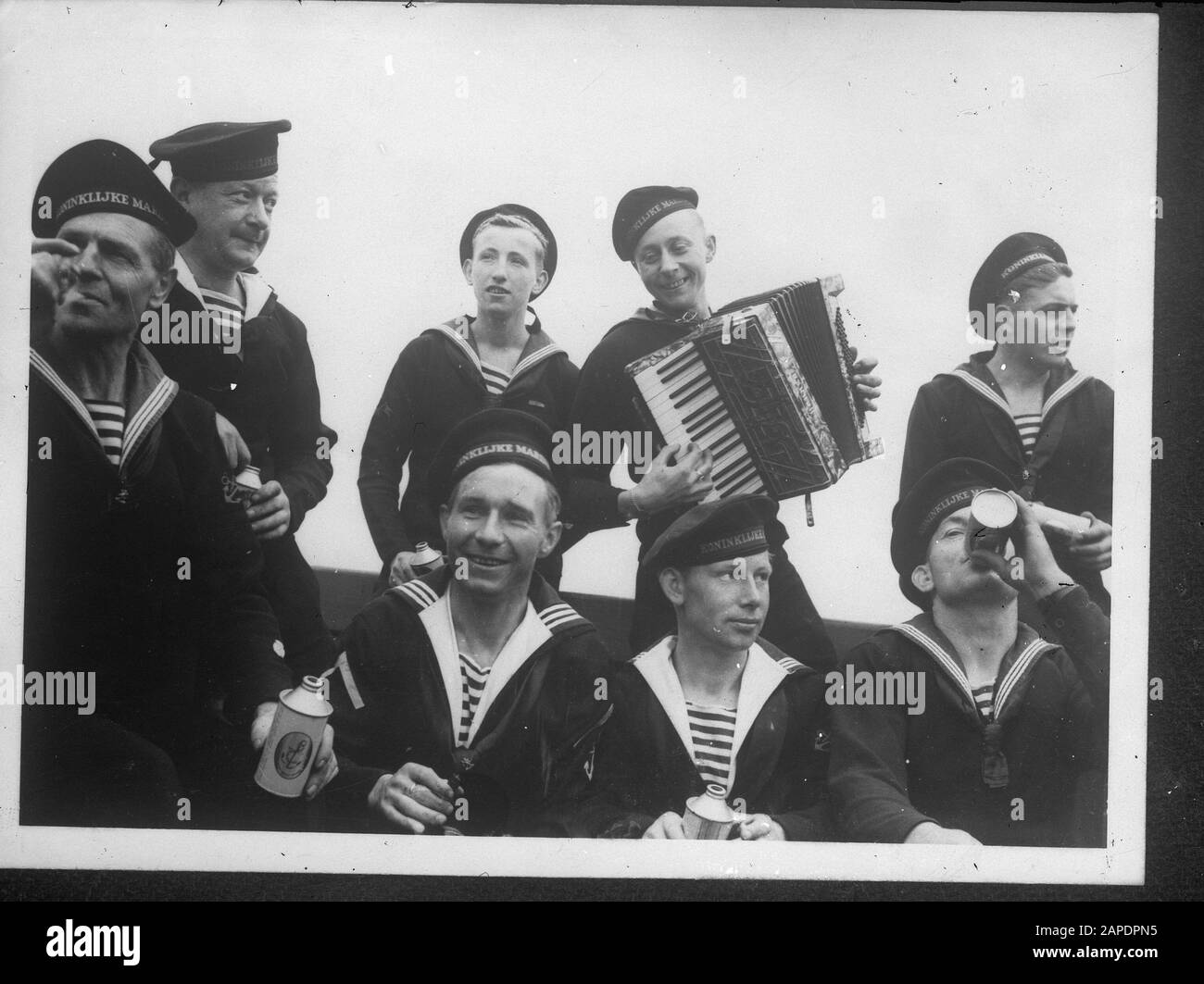 Crew of a minesweeper of the Royal Navy celebrate the commission of ...