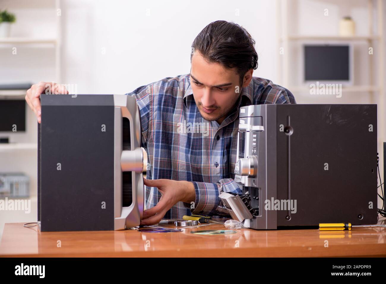 The young engineer repairing musical hi-fi system Stock Photo - Alamy