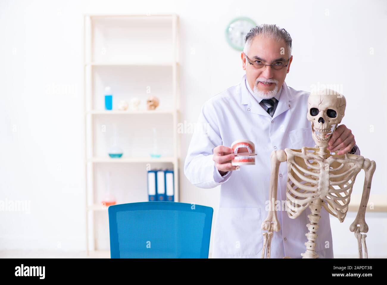 The aged male doctor with skeleton Stock Photo - Alamy
