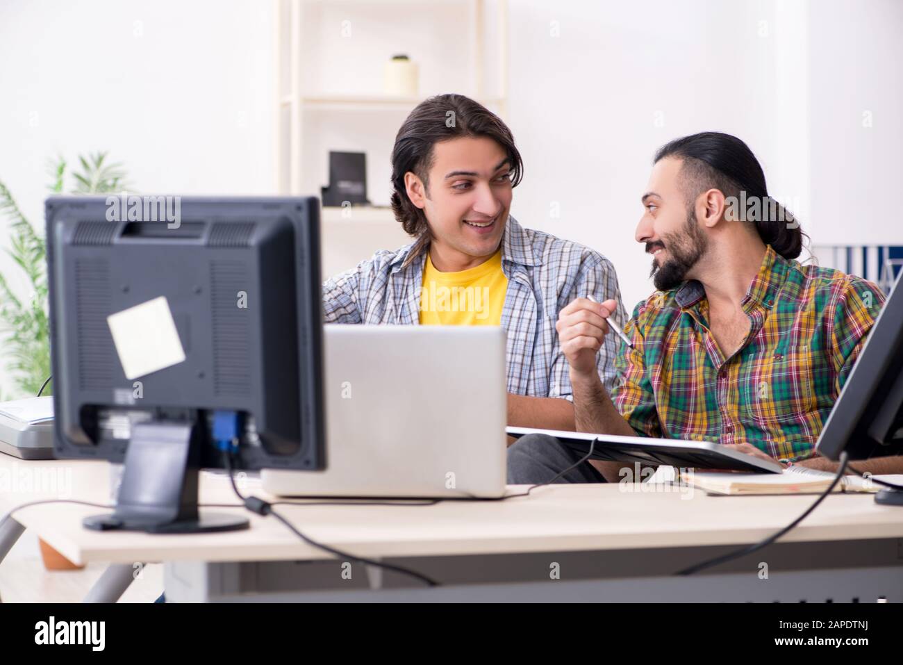 The two it specialists working in the office Stock Photo - Alamy