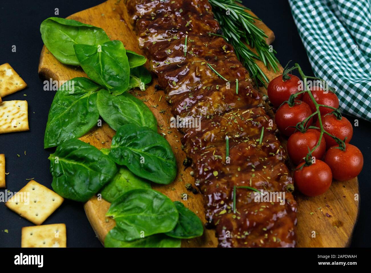 Barbecue Pork Spare Ribs as side view with basil and tomatoes and hot ...