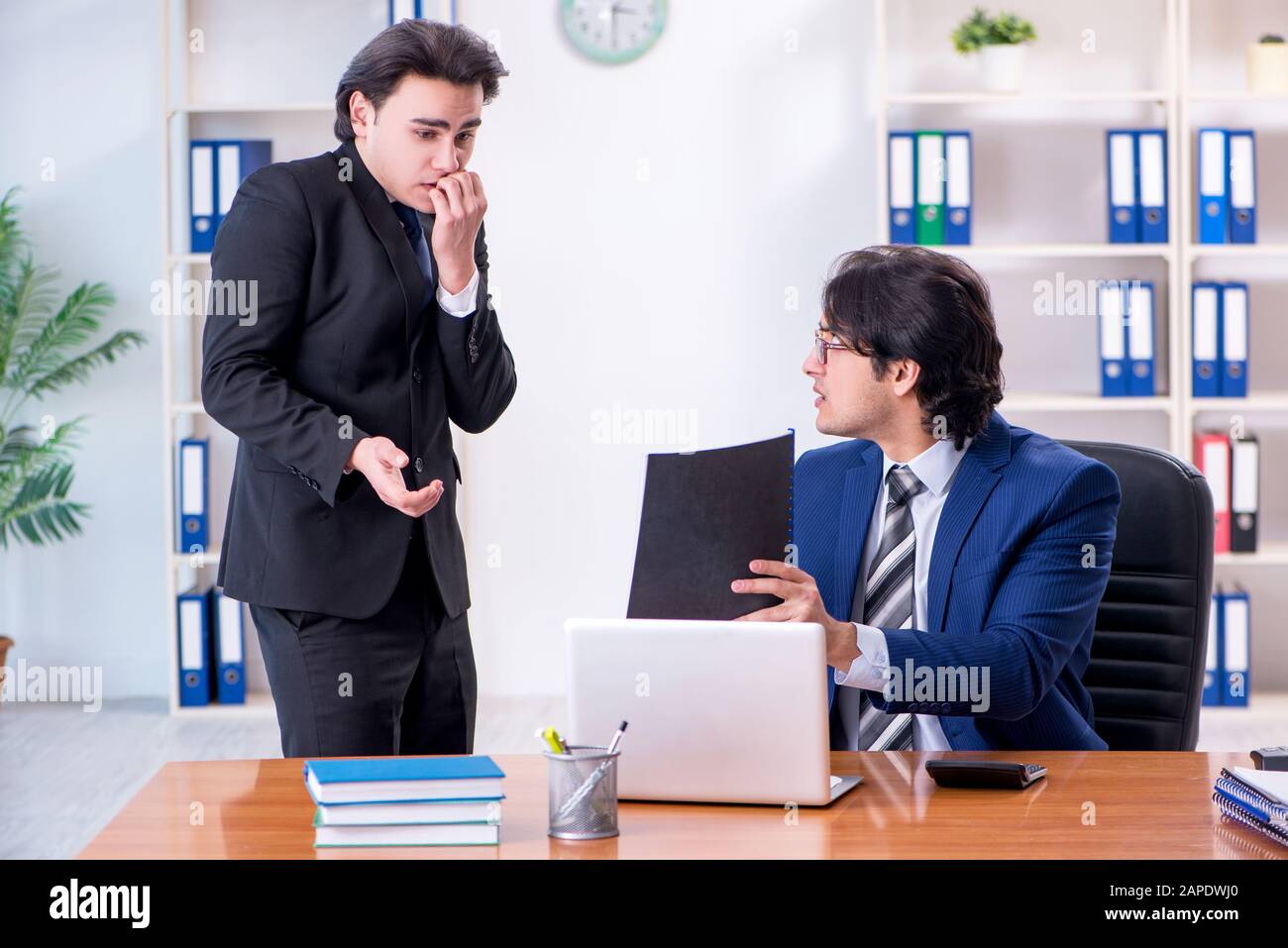 The boss and his male assistant working in the office Stock Photo - Alamy