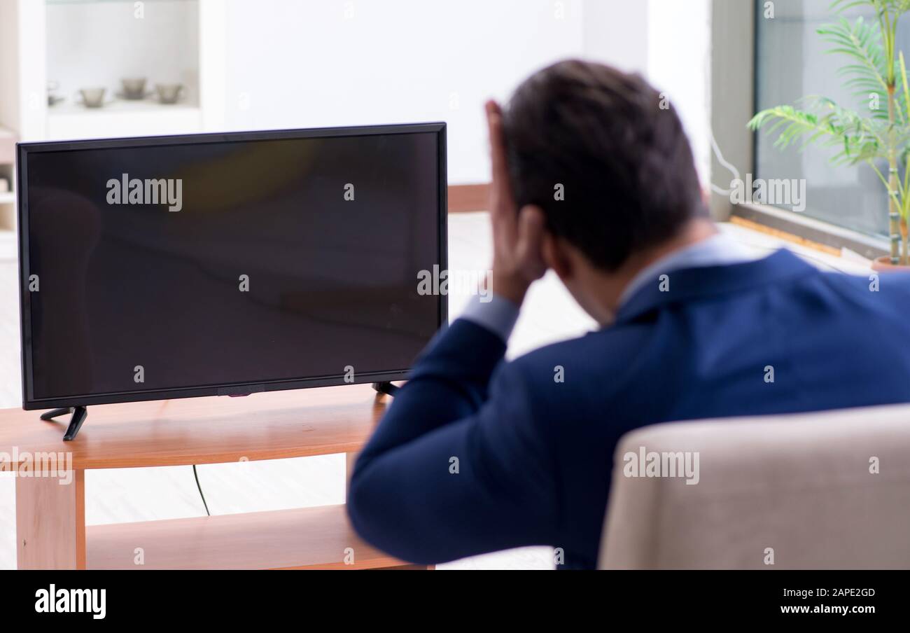 The businessman watching tv in the office Stock Photo - Alamy