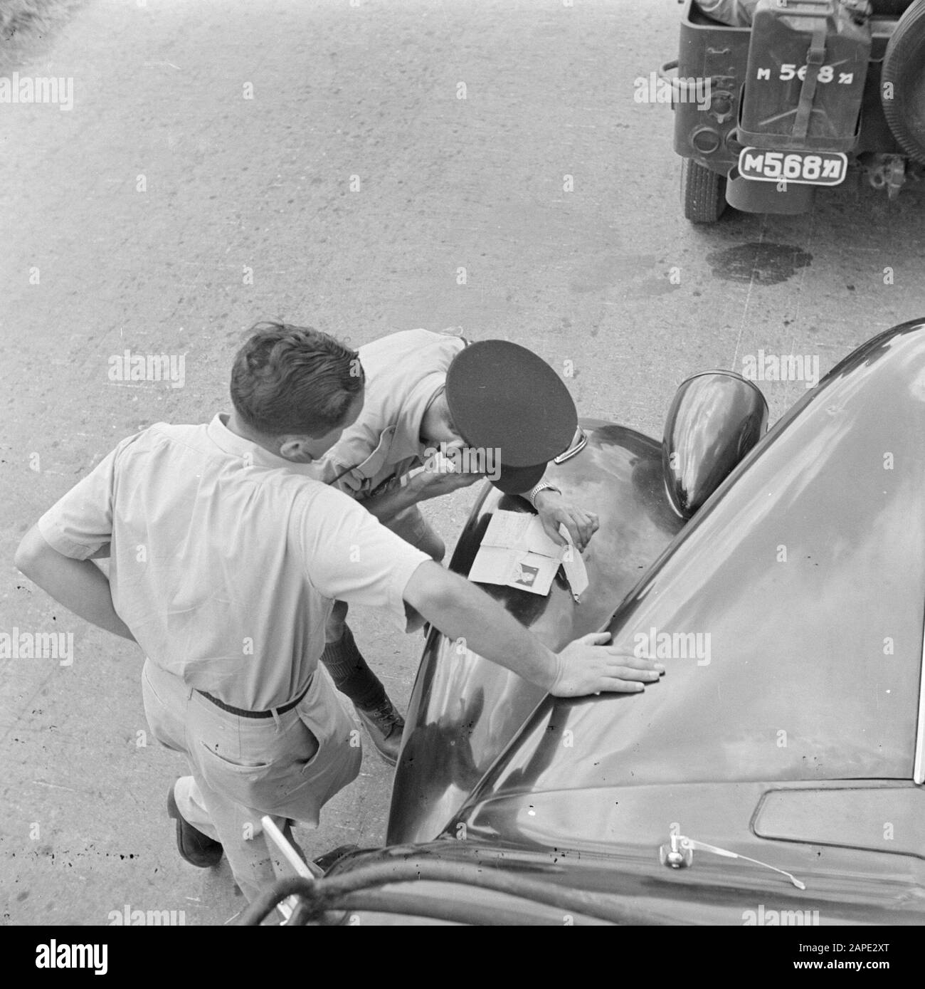 Police officer checks vehicles Black and White Stock Photos & Images ...