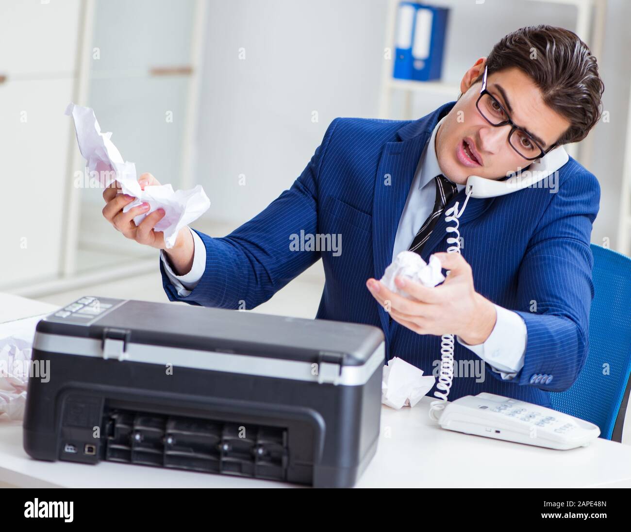 The businessman angry at copying machine jamming papers Stock Photo - Alamy