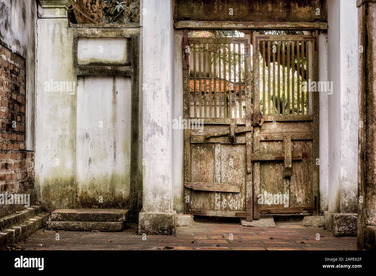 Ancient wooden gate in an old building with weathered walls Stock Photo ...
