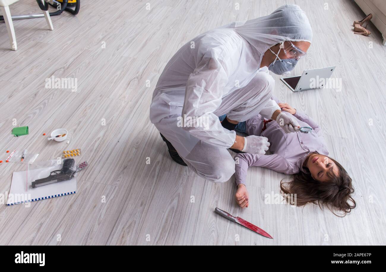 Forensic investigator at the crime scene investigating woman murder ...