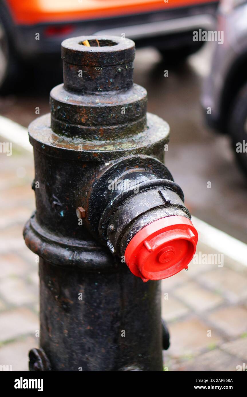Vertical shot of an old fire hydrant on the sidewalk Stock Photo - Alamy