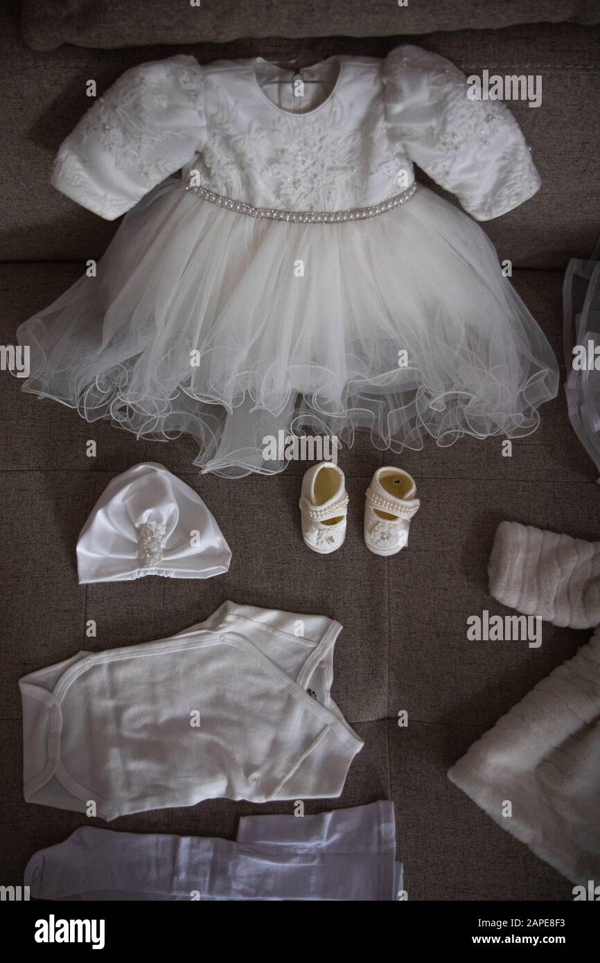 Elegant white baby dress with raffled skirt and some white baby clothes ...