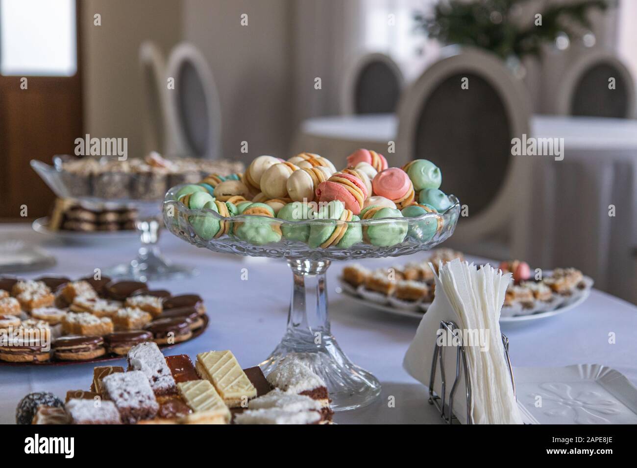 Beautiful dessert setting on a table with Macarons in a crystal glas ...