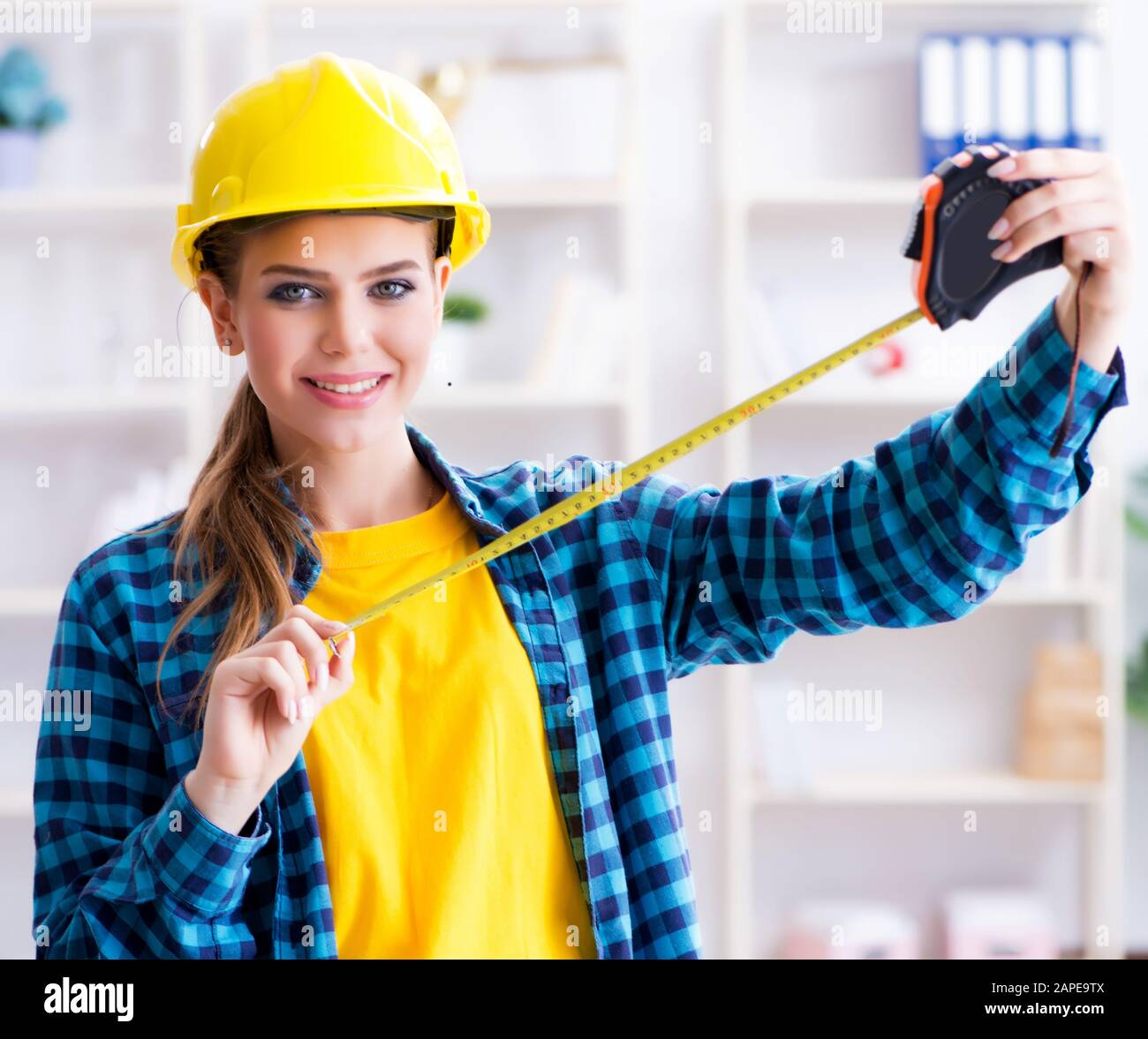The woman in workshop with measuring tape Stock Photo - Alamy