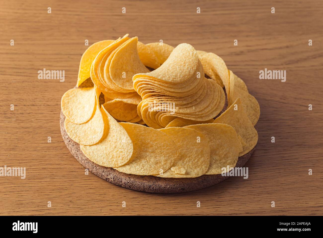 Delicious potato chips, laying on wooden table background Stock Photo ...