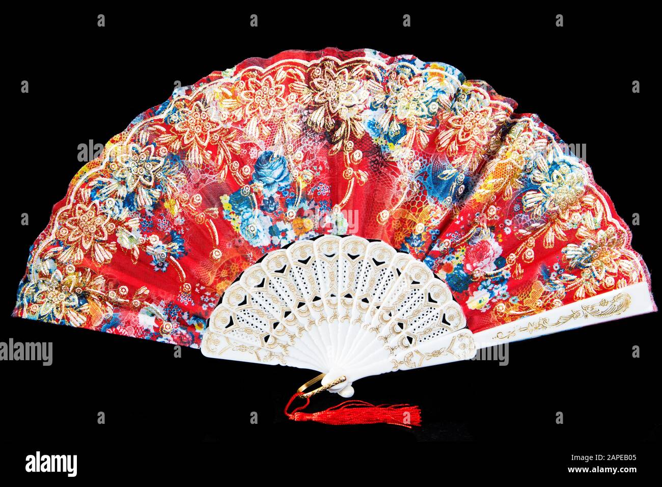 Flamenco hand fan with colorful pattern isolated on black background ...