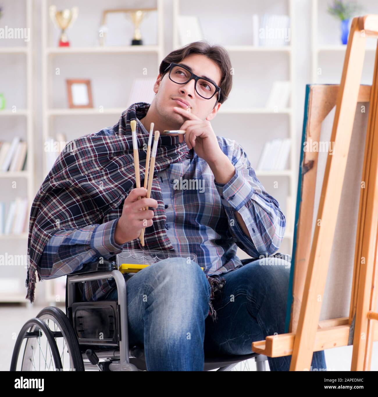 The disabled artist painting picture in studio Stock Photo - Alamy