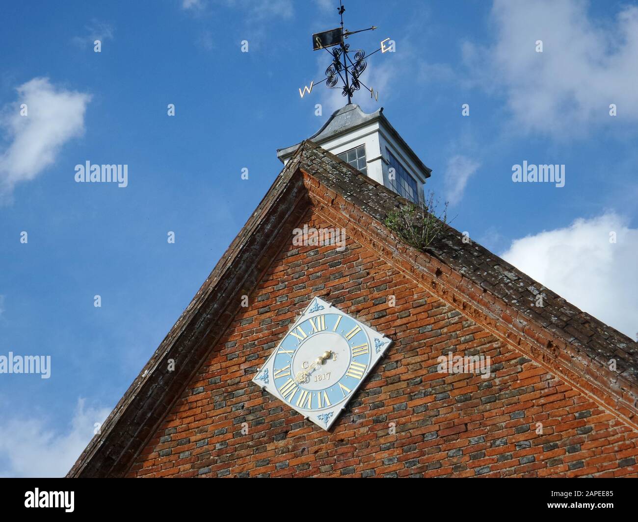 sundial on old building england uk Stock Photo - Alamy
