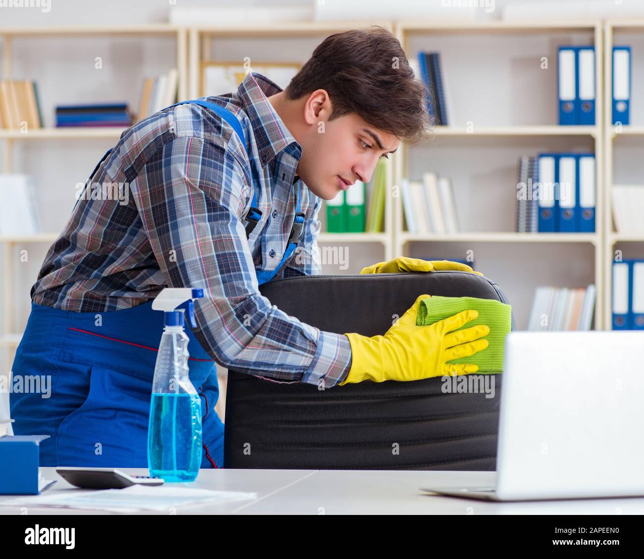 The male cleaner working in the office Stock Photo - Alamy