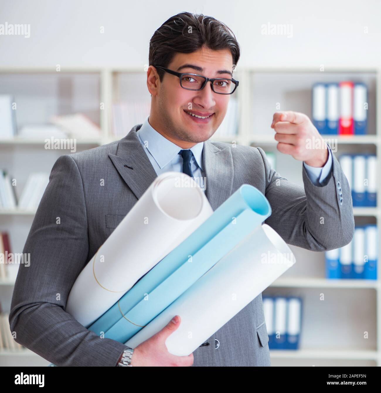 The businessman engineer draftsman with blueprints drawings Stock Photo ...