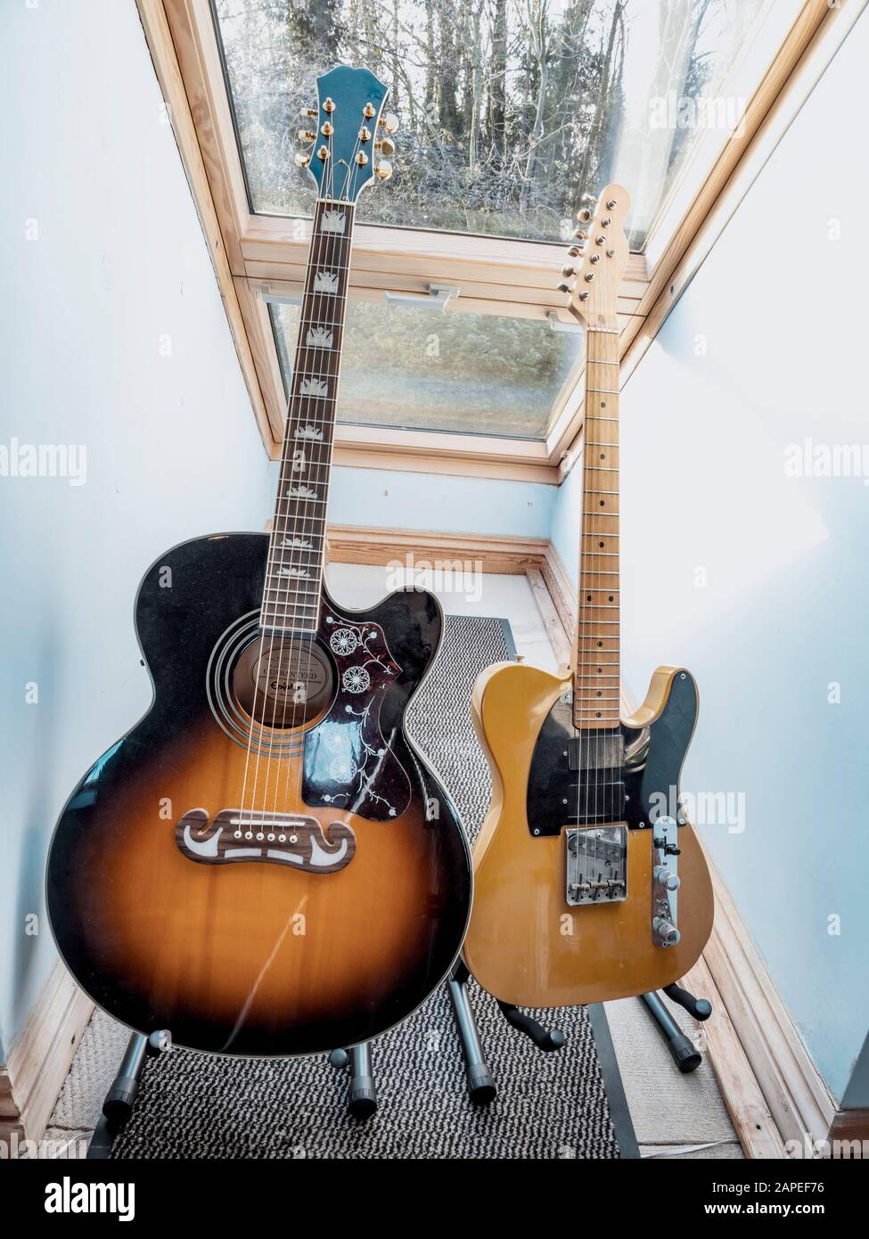 vintage guitars on stands near window Stock Photo - Alamy