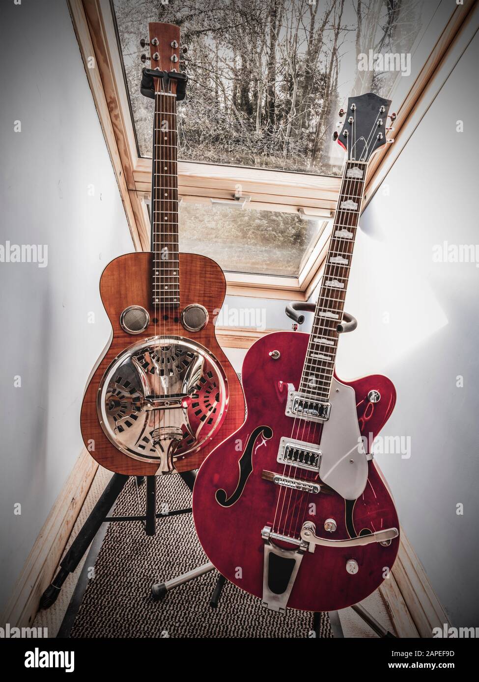vintage guitars on stands near window Stock Photo - Alamy