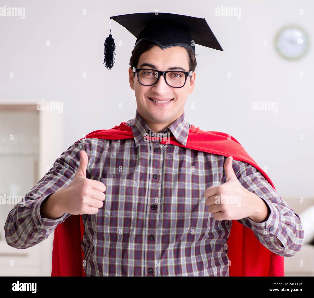 The super hero student wearing mortarboard in a red cloak Stock Photo ...