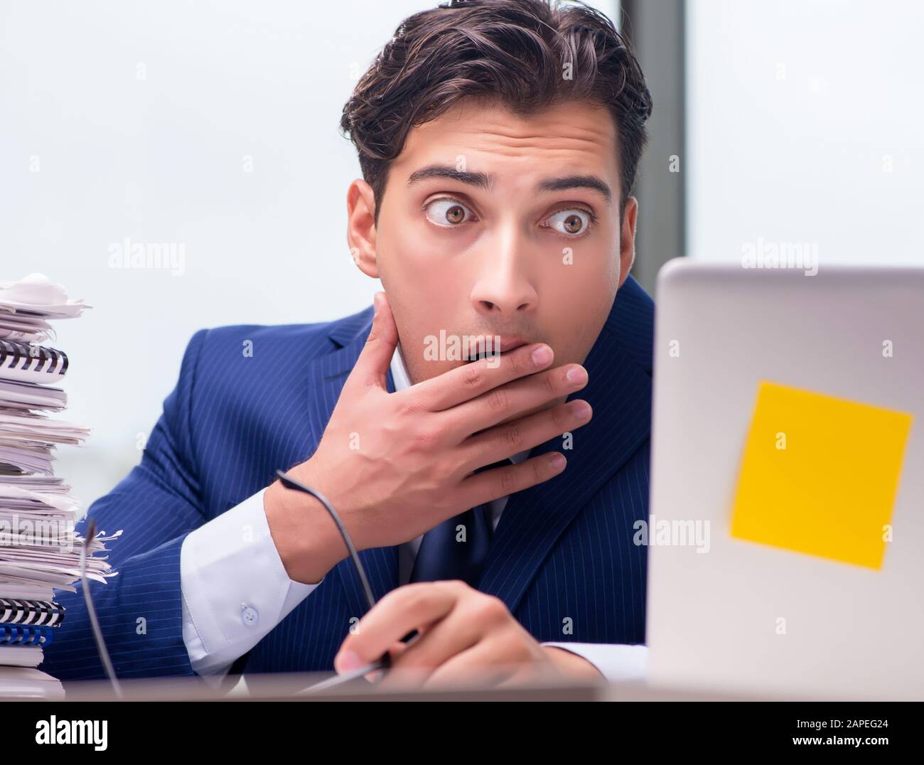 The workaholic businessman overworked with too much work in office ...