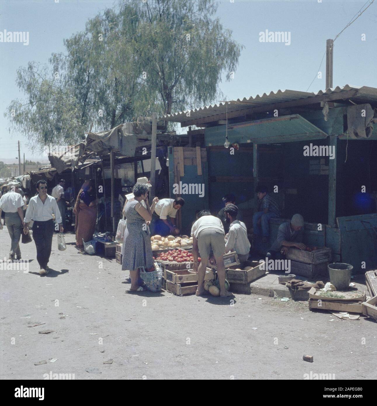Bersjeba. Market table: fruit and vegetable trader with customers at ...