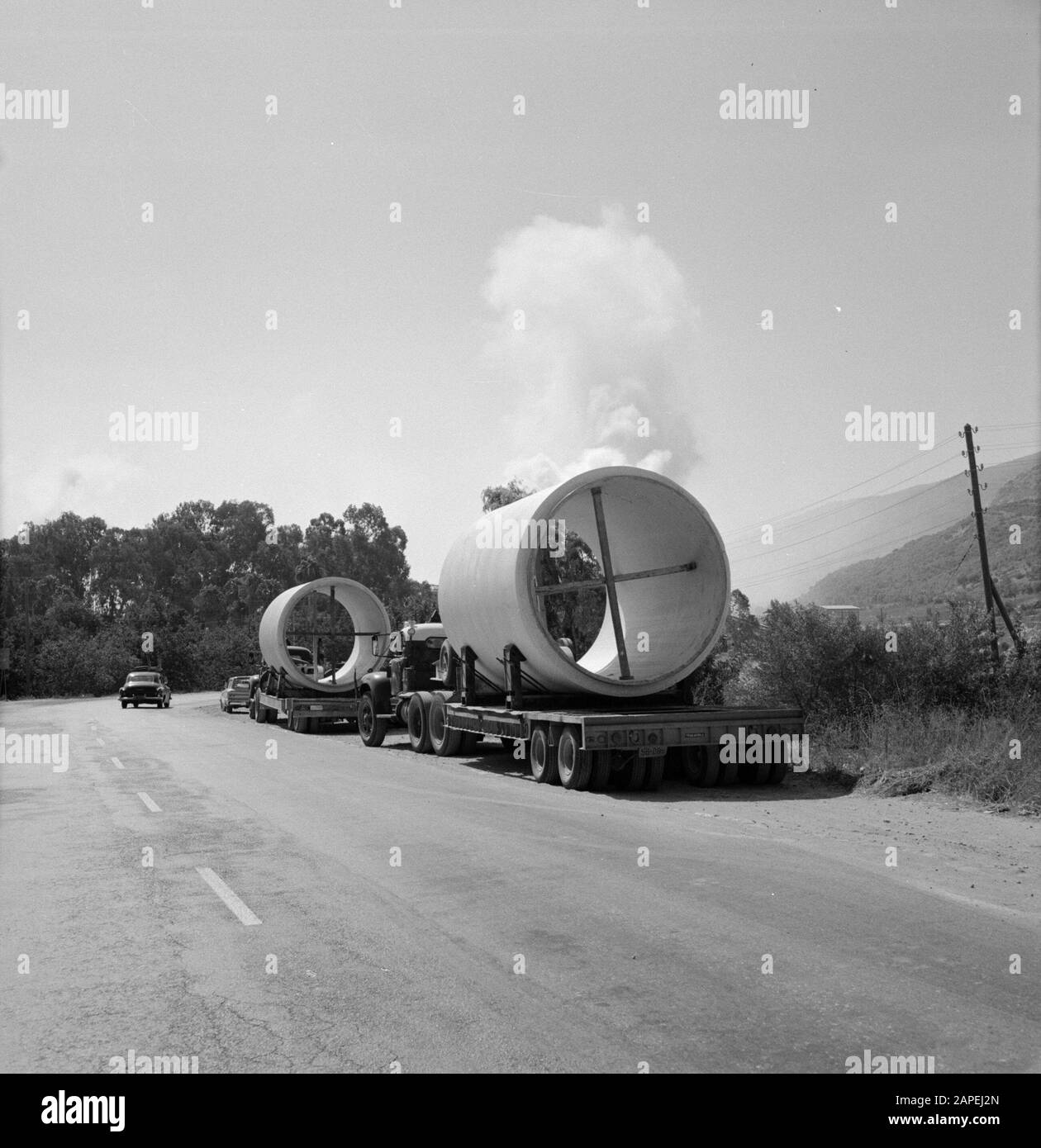 Concrete water pipes loaded on special transport cars. The tubes are ...